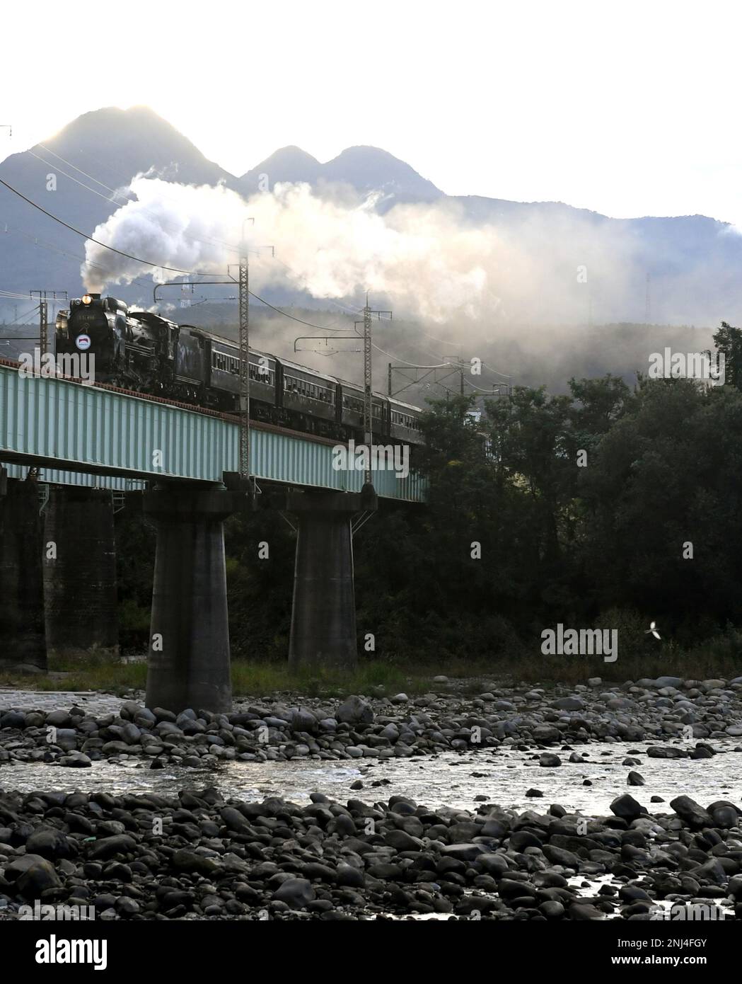 Railroad fans take photos of an SL( steam locomotive) train running ...