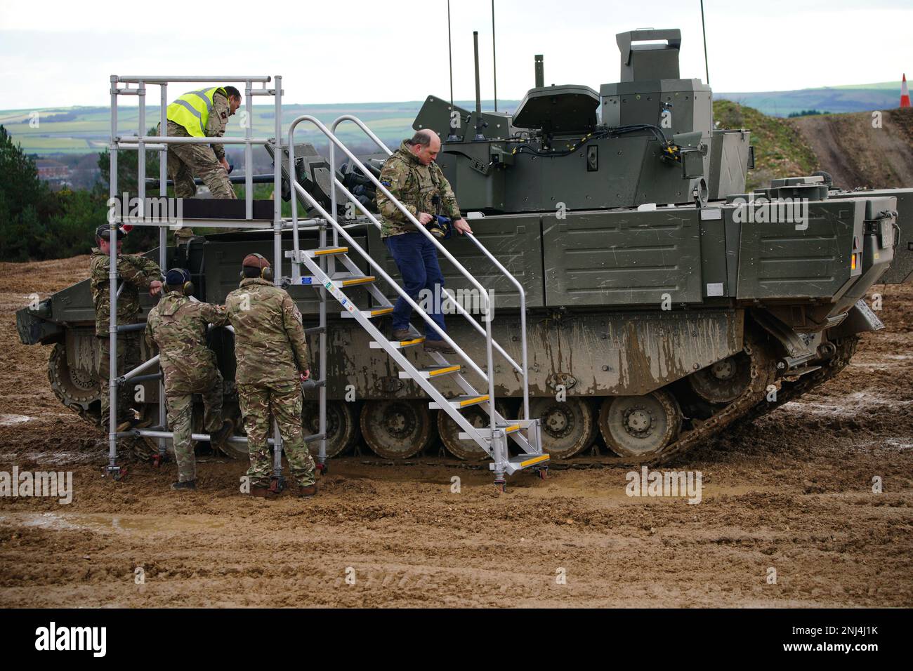 Defence Secretary Ben Wallace uses steps to climb down from a tank ...