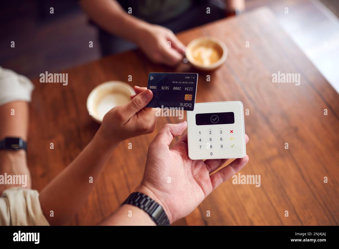 Close Up Of Customer Making Contactless Payment In Coffee Shop Using ...