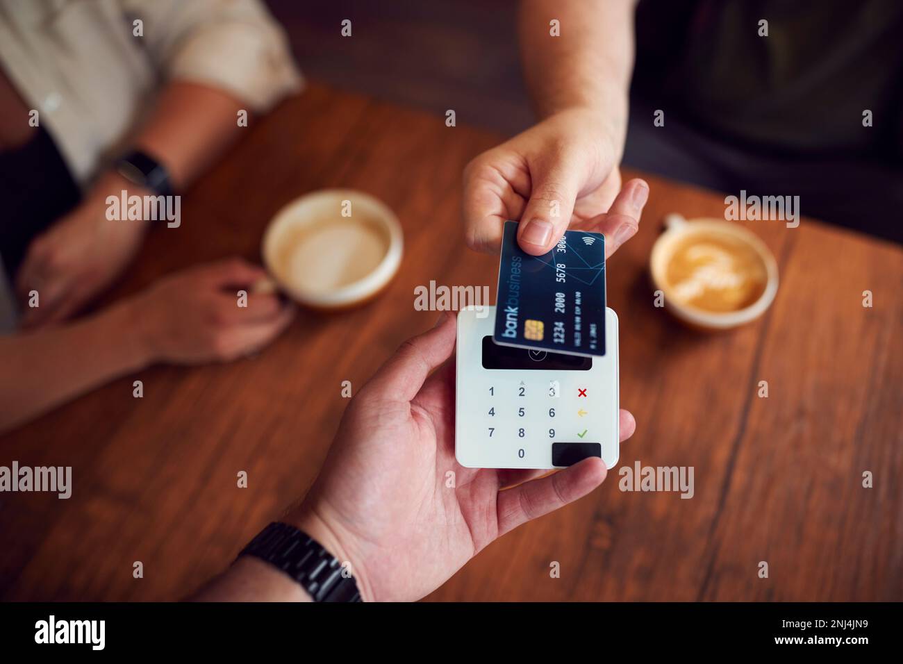 Close Up Of Customer Making Contactless Payment In Coffee Shop Using ...