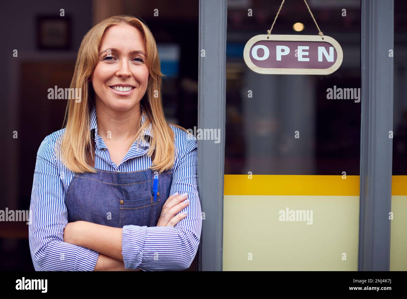 Portrait Of Female Owner Or Staff Standing Outside Shop Or Store With ...