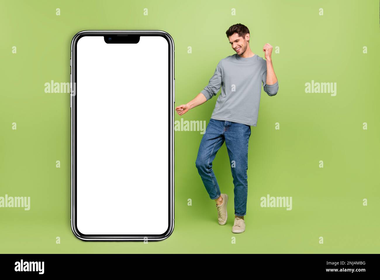 Full size photo of cheerful handsome guy have fun dancing promote phone ...