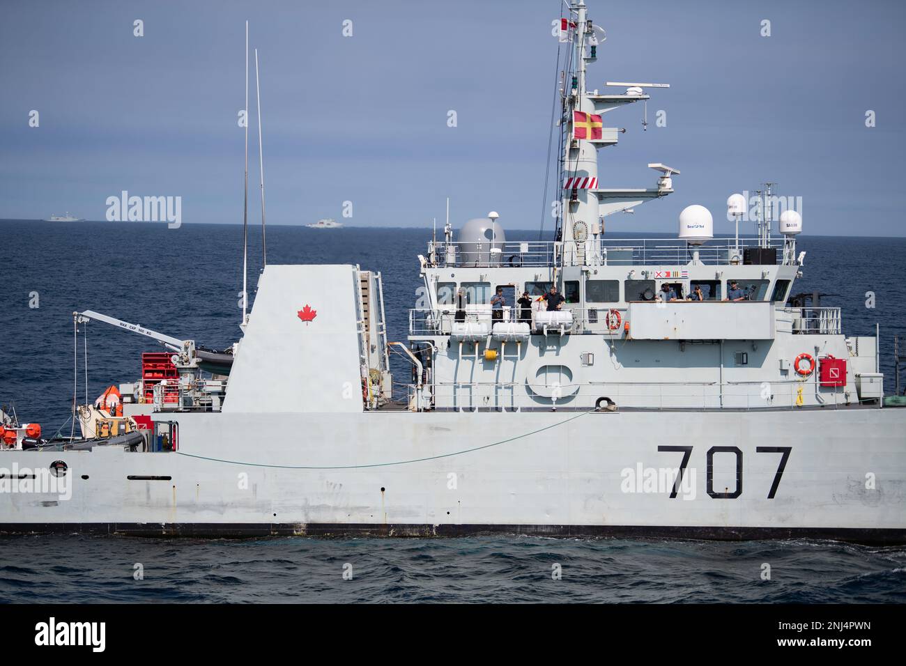 Royal Canadian Navy sailors aboard HMCS Goose Bay glance from their ...