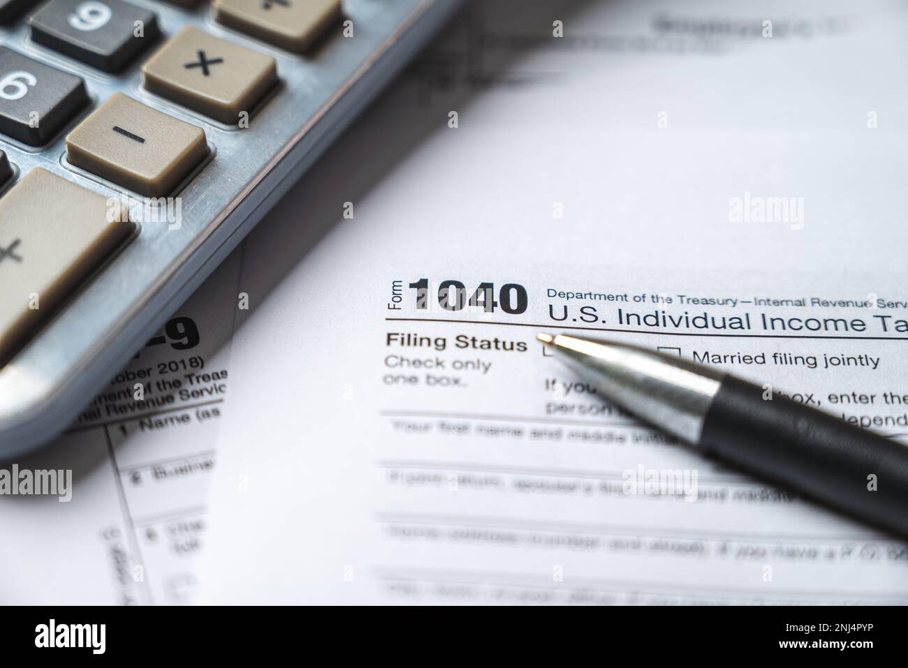 Financial time tax return forms with pen and calculator Stock Photo - Alamy