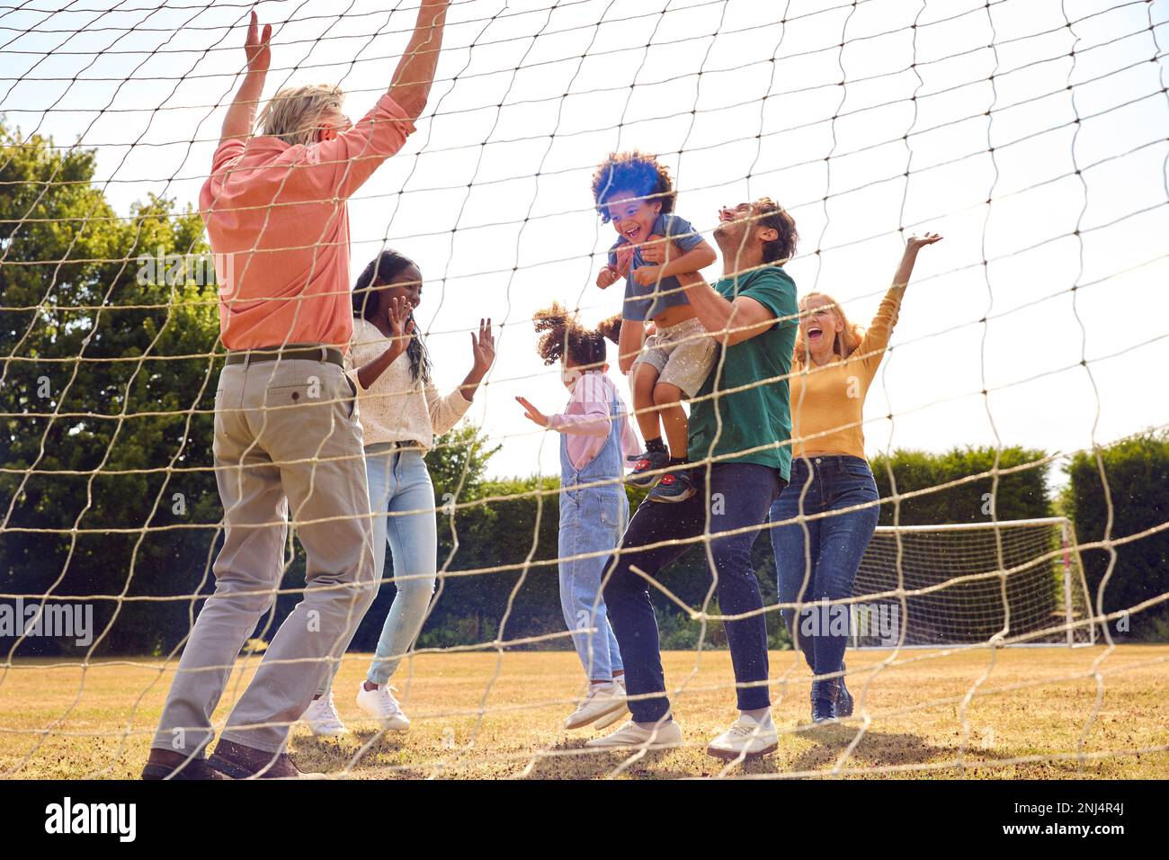 Multi-Generation Family At Home In Garden Playing Football Or Soccer Together Stock Photo - Alamy