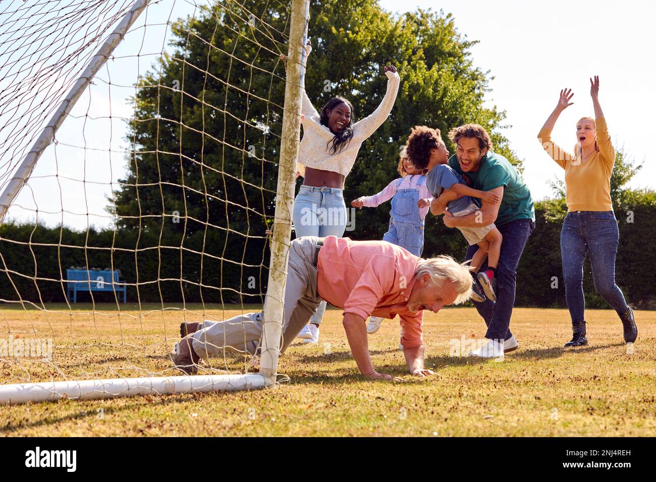 Multi-Generation Family At Home In Garden Playing Football Or Soccer Together Stock Photo - Alamy