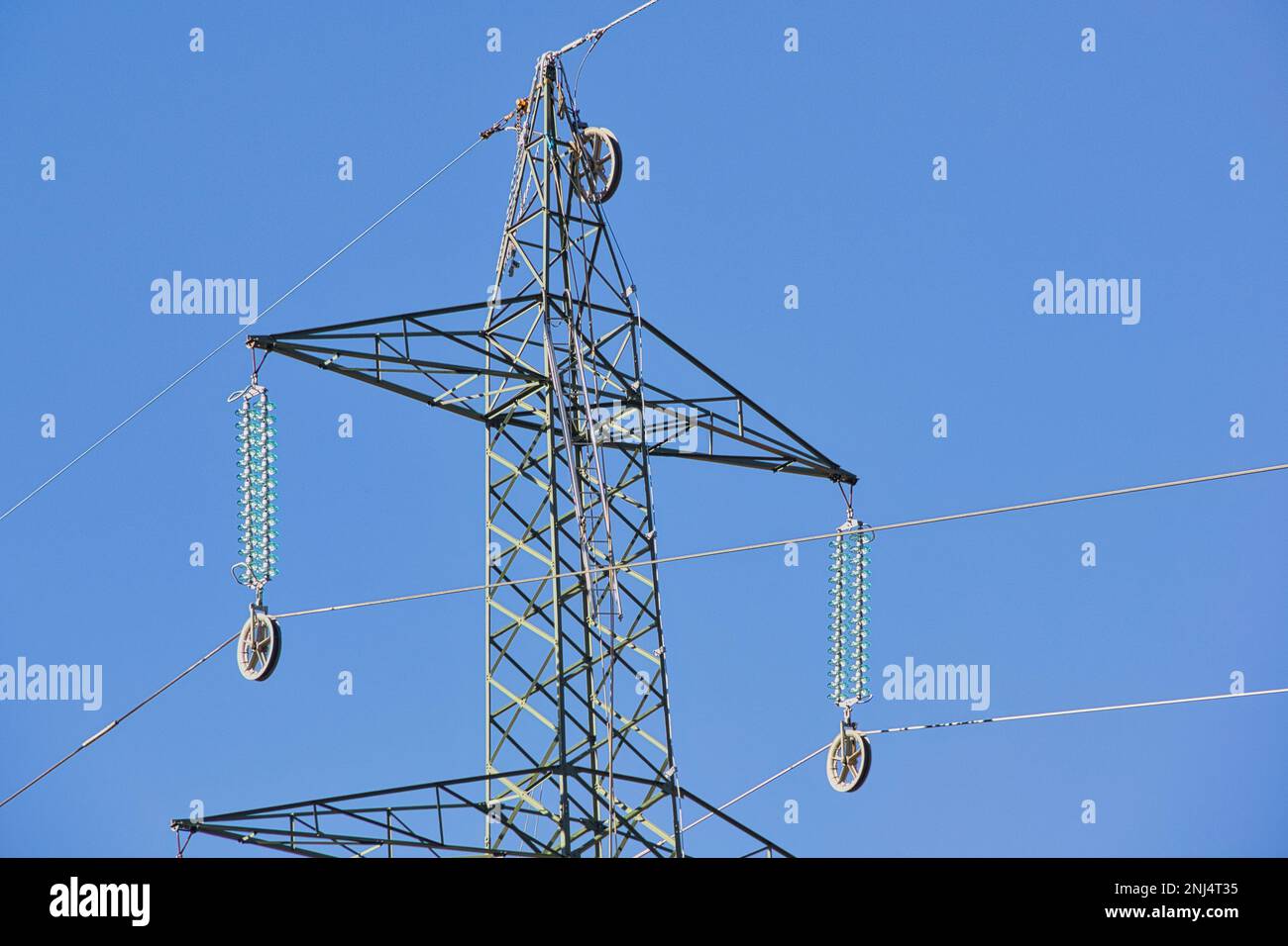 Iron pylon with high voltage cable insulators Stock Photo - Alamy