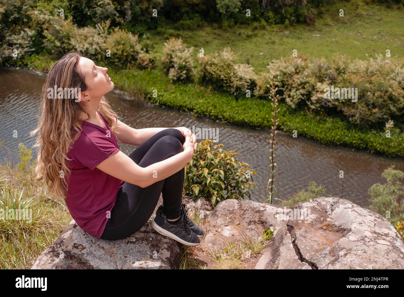 Woman enjoying the warm sunlight in nature Stock Photo - Alamy