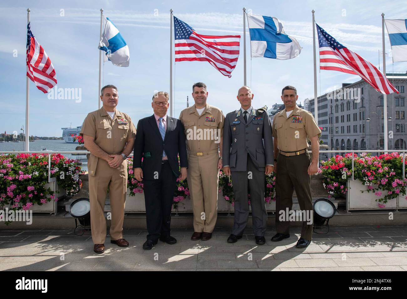 U.S. Navy Capt. Aaron Kelly, commodore of Amphibious Squadron Six, left ...