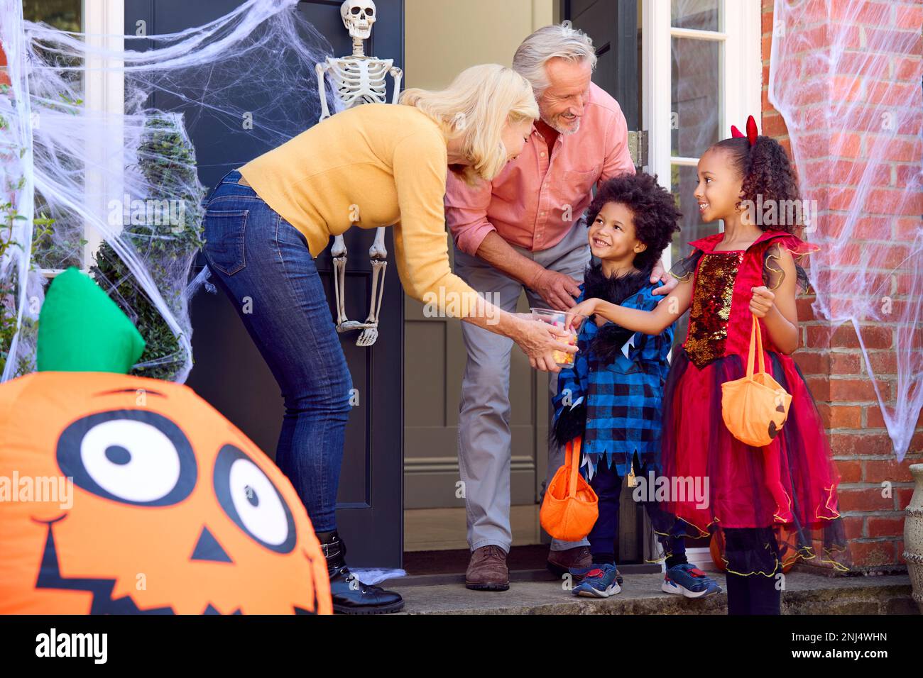 Grandchildren Dressing Up And Visiting Grandparent's House Trick Or ...