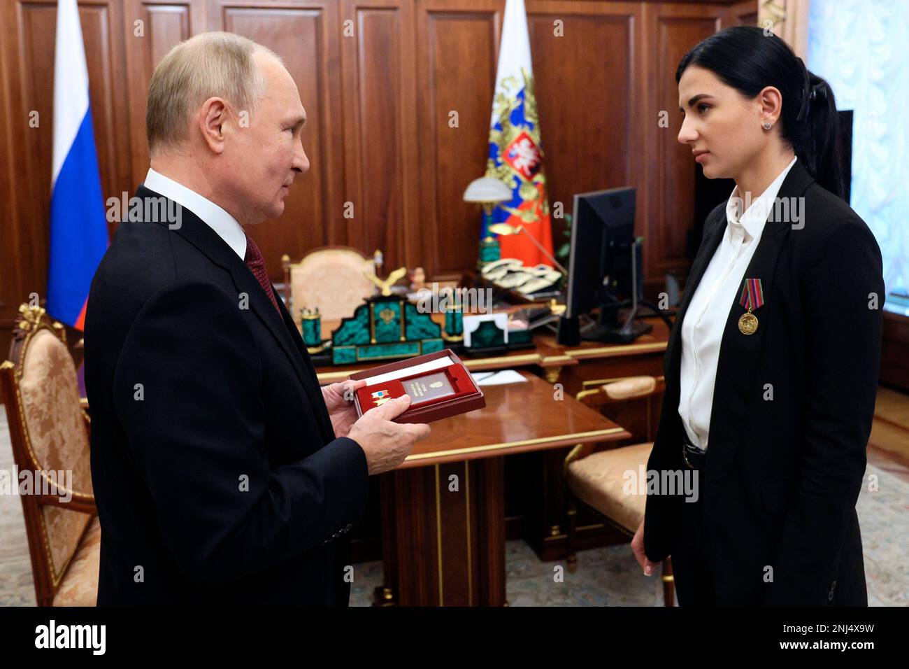 Russian President Vladimir Putin speaks to Elena Karabet, daughter of ...