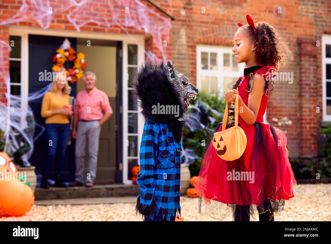 Grandchildren Dressing Up And Visiting Grandparent's House Trick Or ...