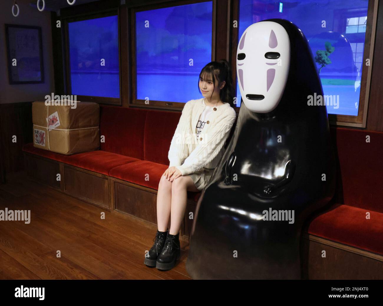 A girl poses with Kaonashi, No-Face a character in the film, Spirited ...