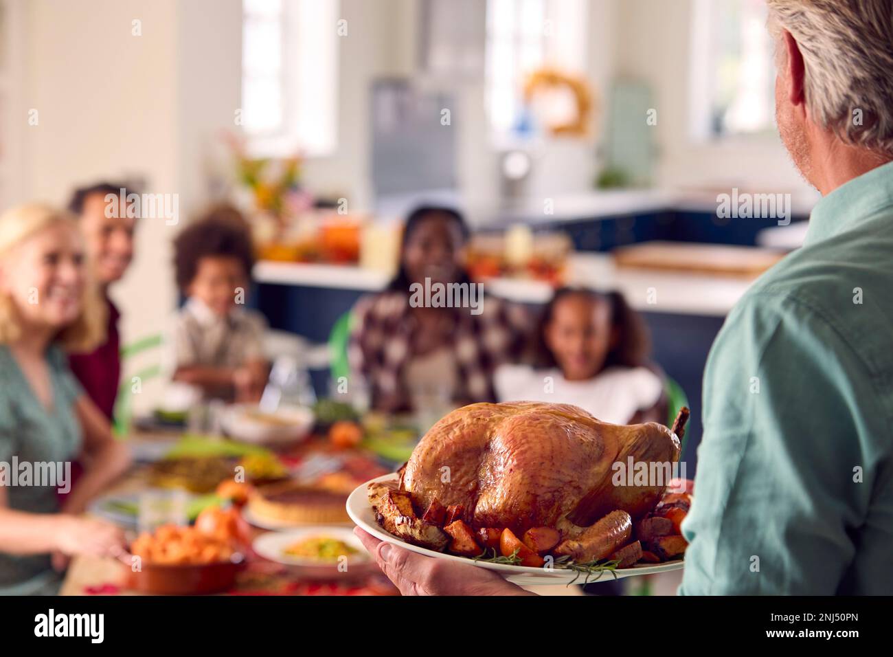Grandfather Serving As Multi-Generation Family Celebrating Thanksgiving ...