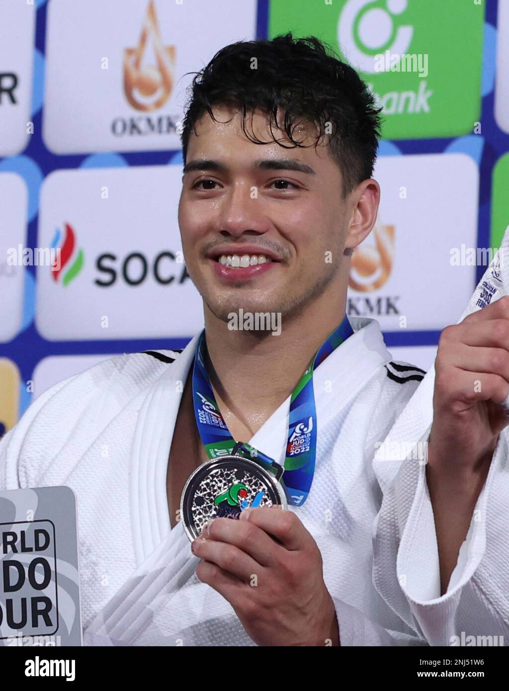 Correction: Kyle Reyes of Canada celebrates during an award ceremony of ...