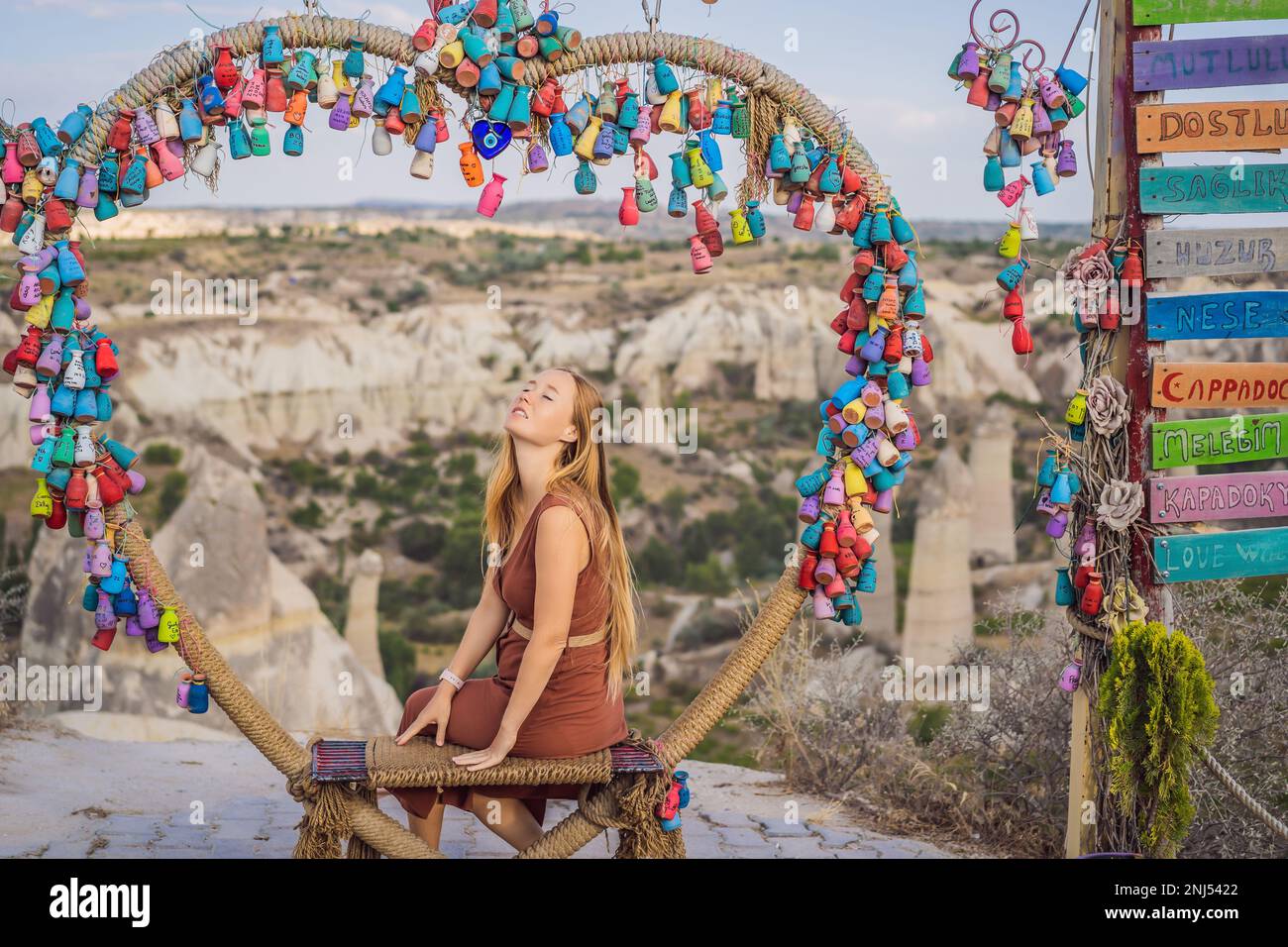 Young woman exploring valley with rock formations and fairy caves near ...
