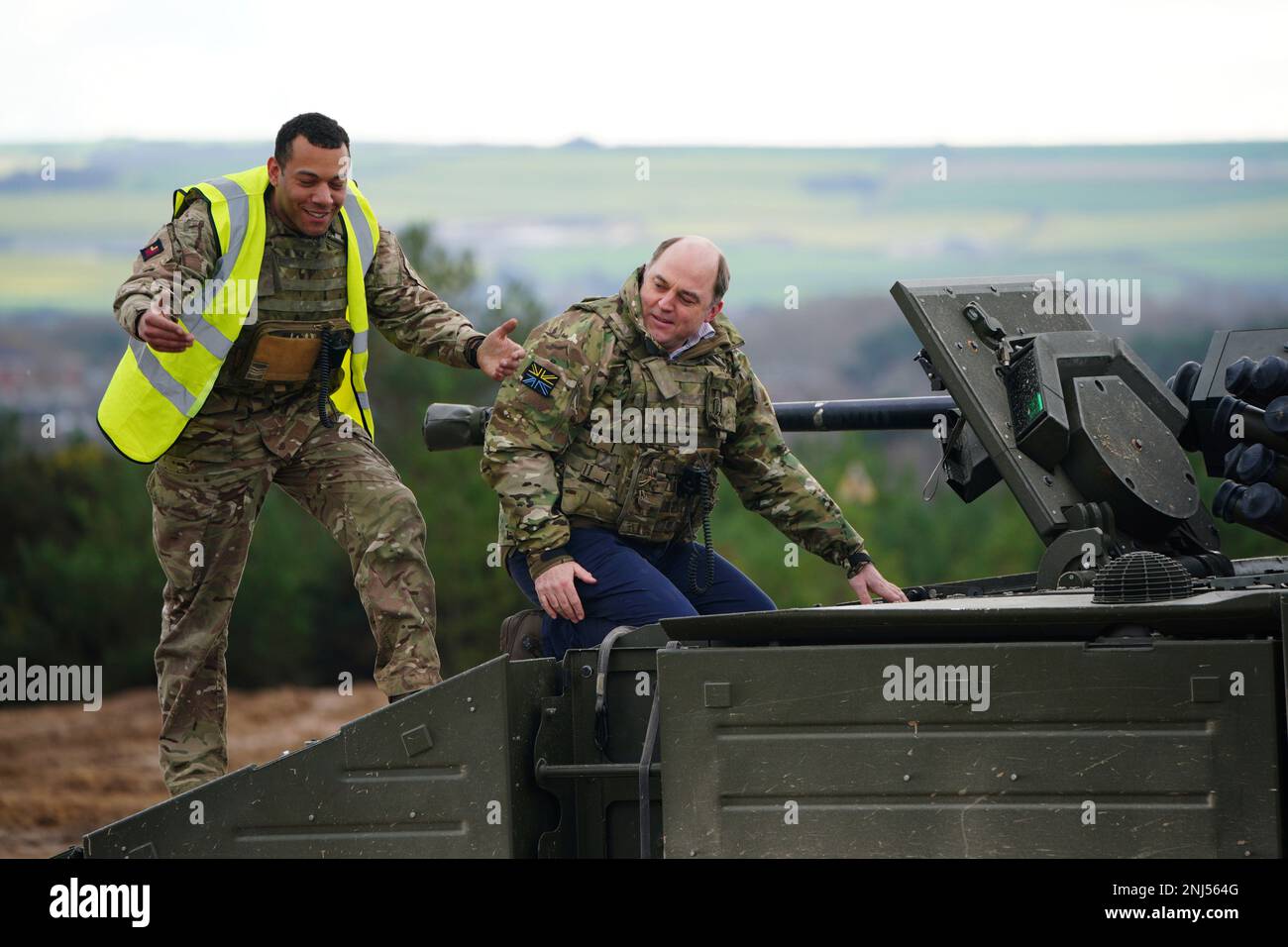 Britain's Defence Secretary Ben Wallace climbs out of an Ajax armoured ...