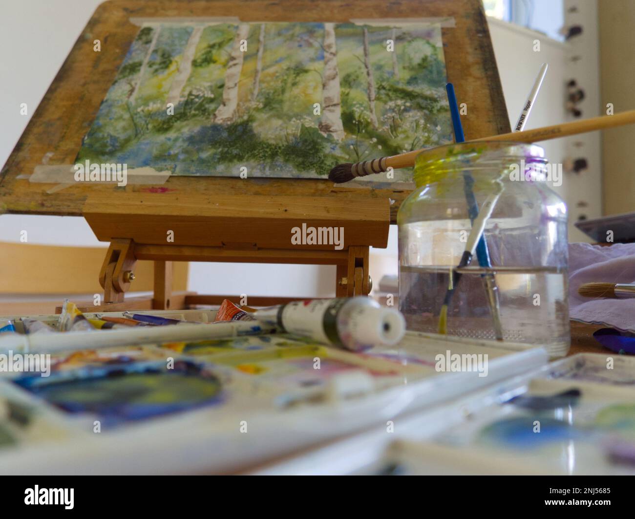 artists easel with watercolour palette and paintburshes Stock Photo - Alamy