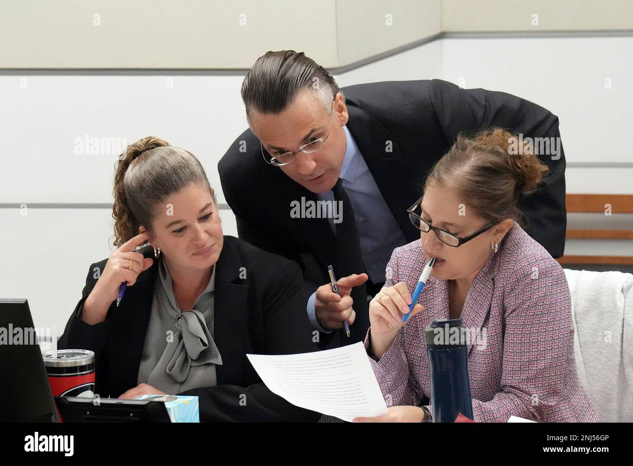 Capital defense attorney Casey Secor, center, speaks with Assistant ...