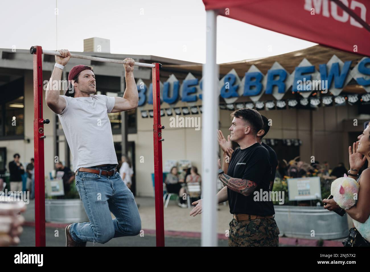 A fair attendee attempts pull-ups during a Marine Corps pull-up ...