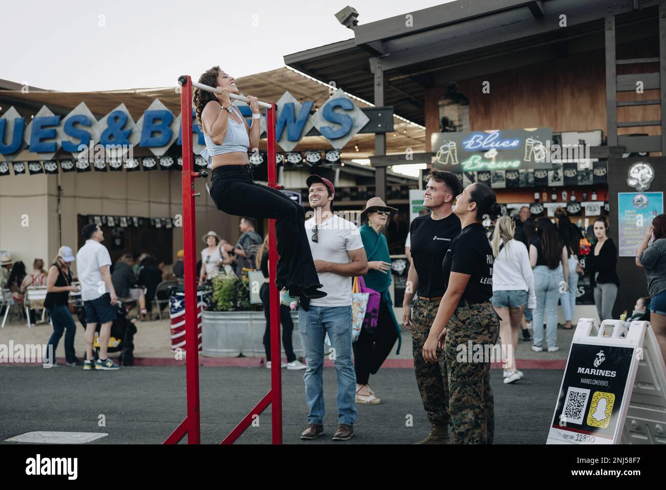 A fair attendee attempts pull-ups during a Marine Corps pull-up ...