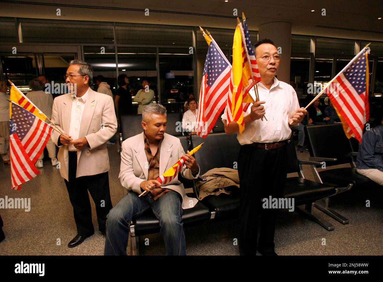 VIETNAM00 14.jpg Left to right--Trang Do, 63 years old, Michael Luu, 43 years old, and Tri Cao ...