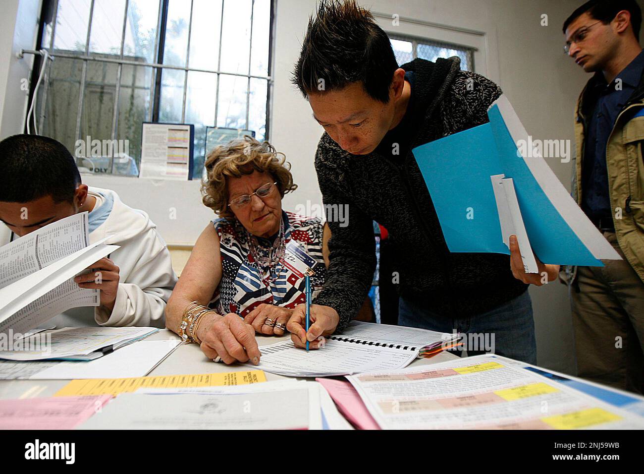 Joseph Chang signs in to vote at the Wash Place--3377 Mission St. (Liz ...