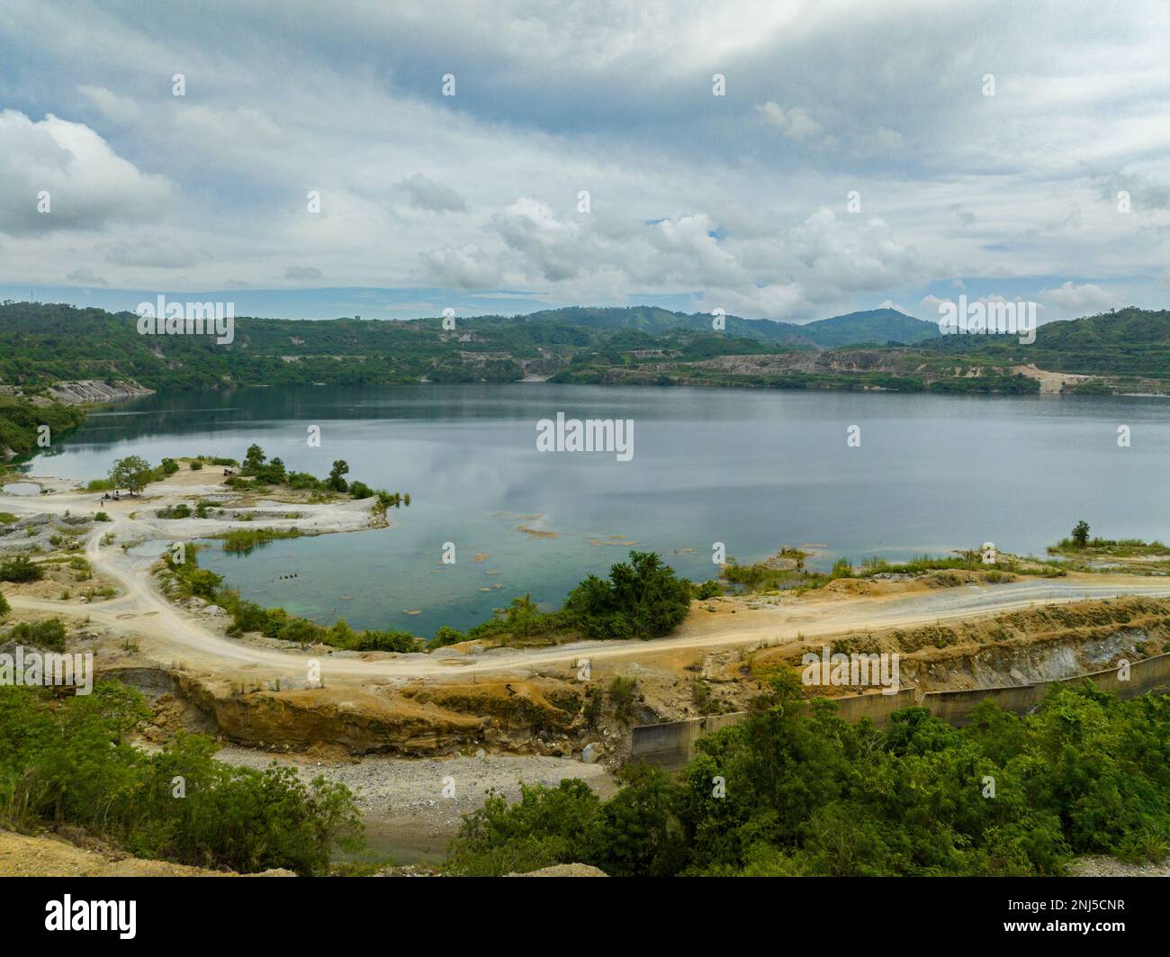 Mining quarry with flooded bottom. Lake with blue water near sand pit ...