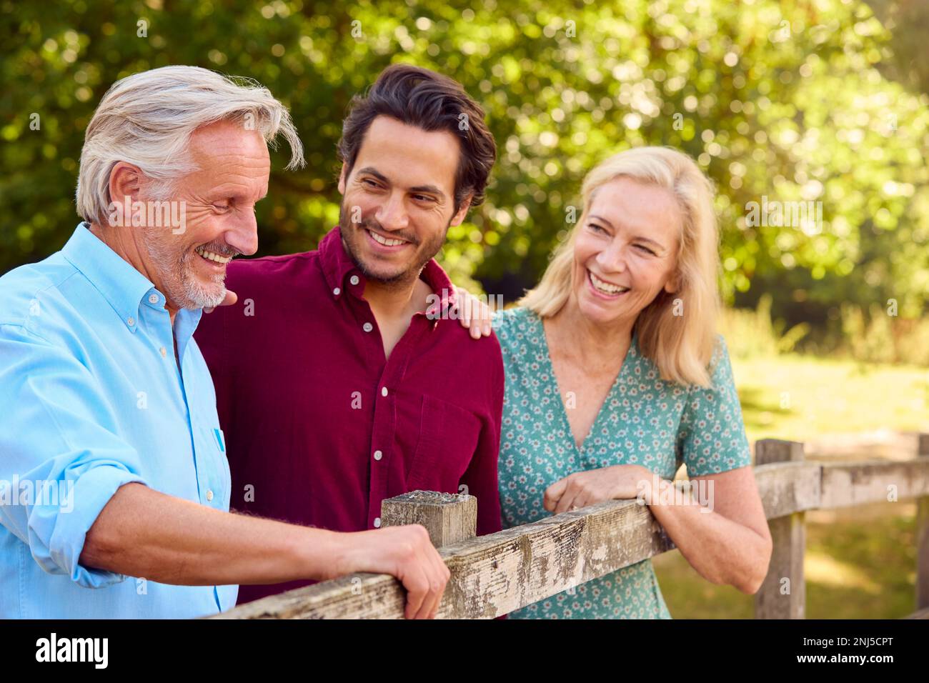 Smiling Family With Mature Parents And Adult Offspring On Walk In ...