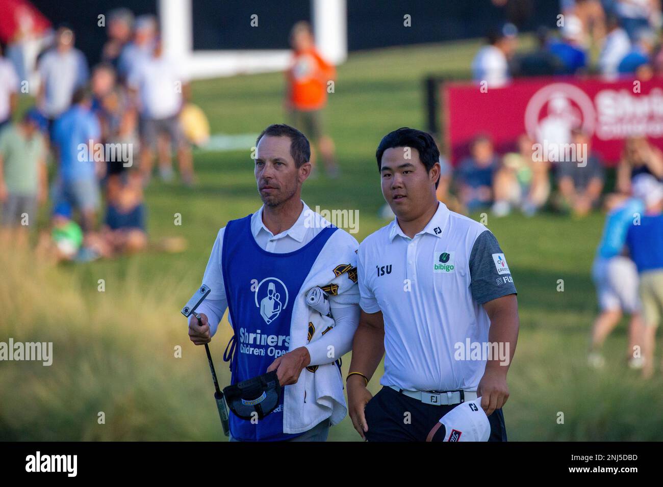 LAS VEGAS, NV - OCTOBER 09: Tom Kim and his caddy walk off the green ...