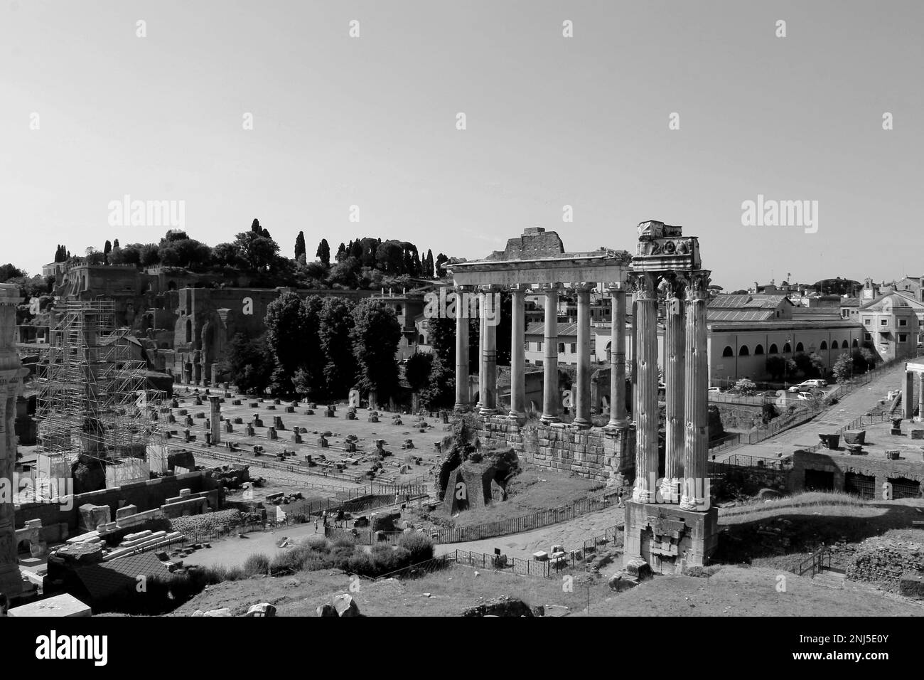 A grayscale shot of a historical scene featuring a clock tower atop a ...