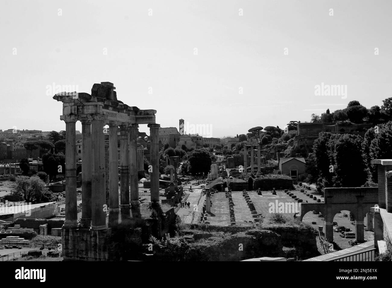 A grayscale shot of a historical scene featuring a clock tower atop a ...