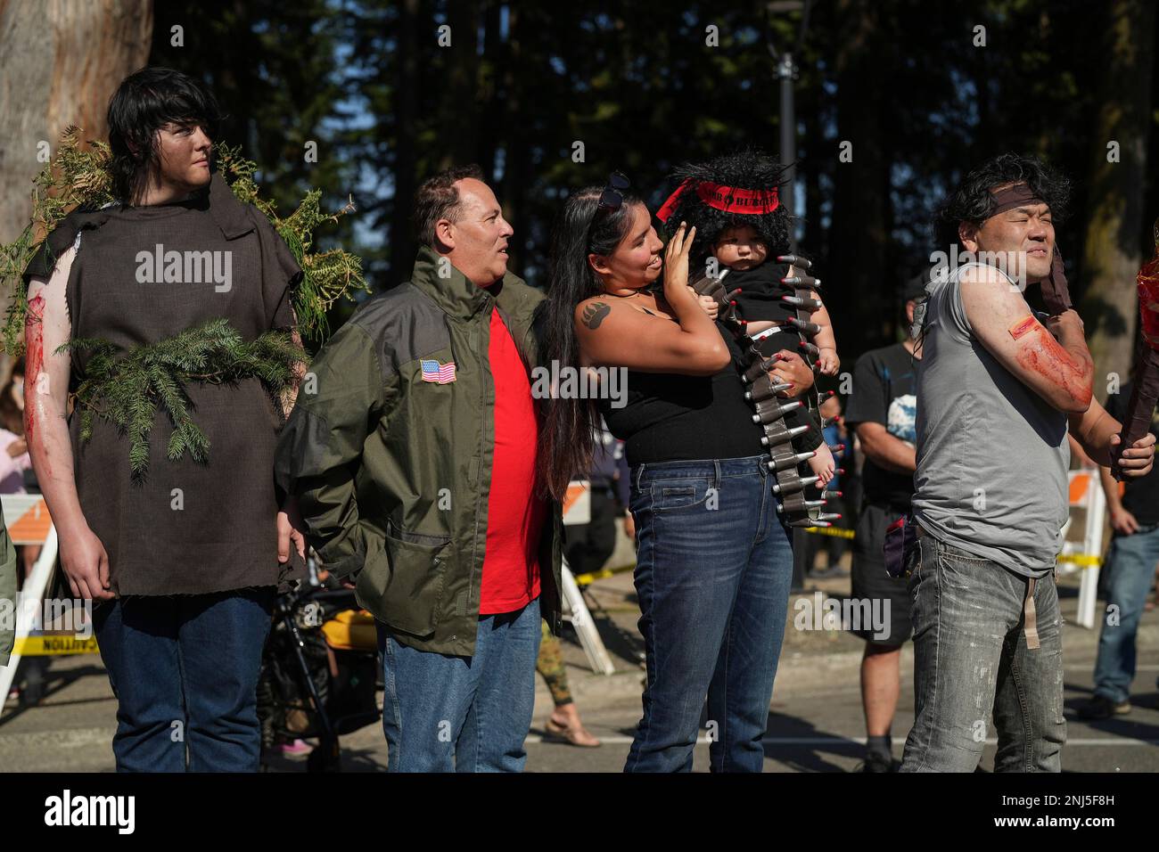 Cheyenne Bouchie, third left, holds her son Rambo Danger Bouchie, 9 ...