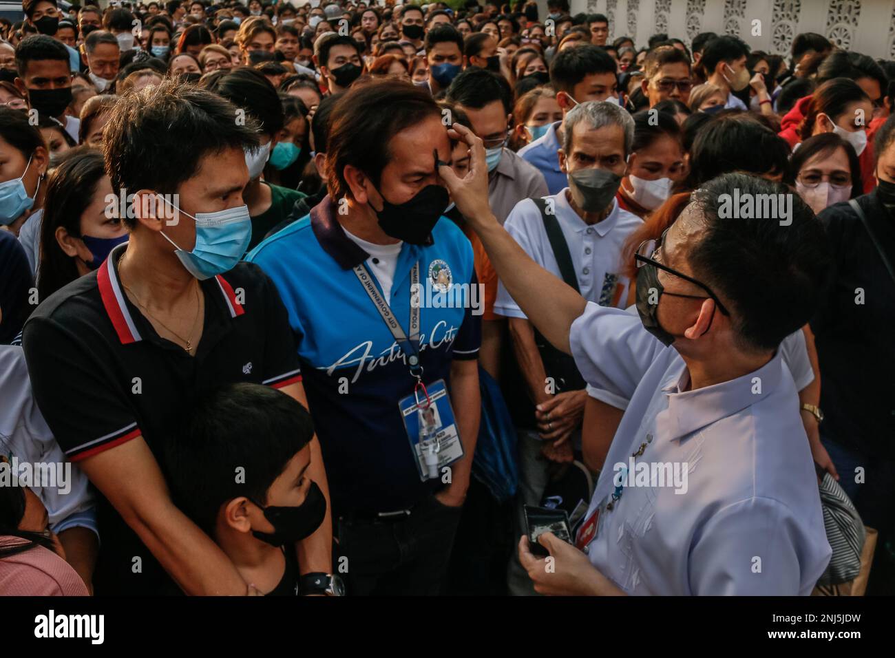 Antipolo City, Rizal, Philippines. 22nd Feb, 2023. Worshipper receives ...