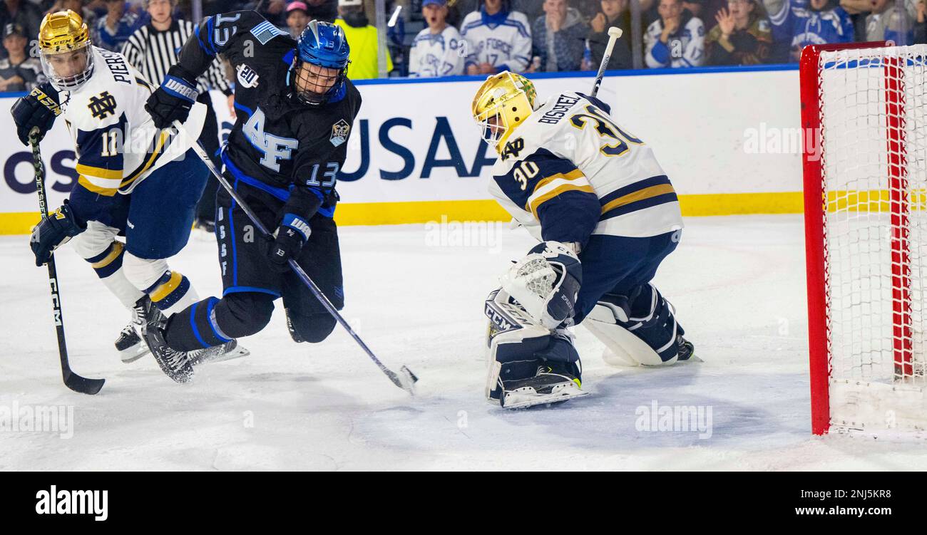 Air Force forward Mason McCormick (13) falls to the ice while shooting ...