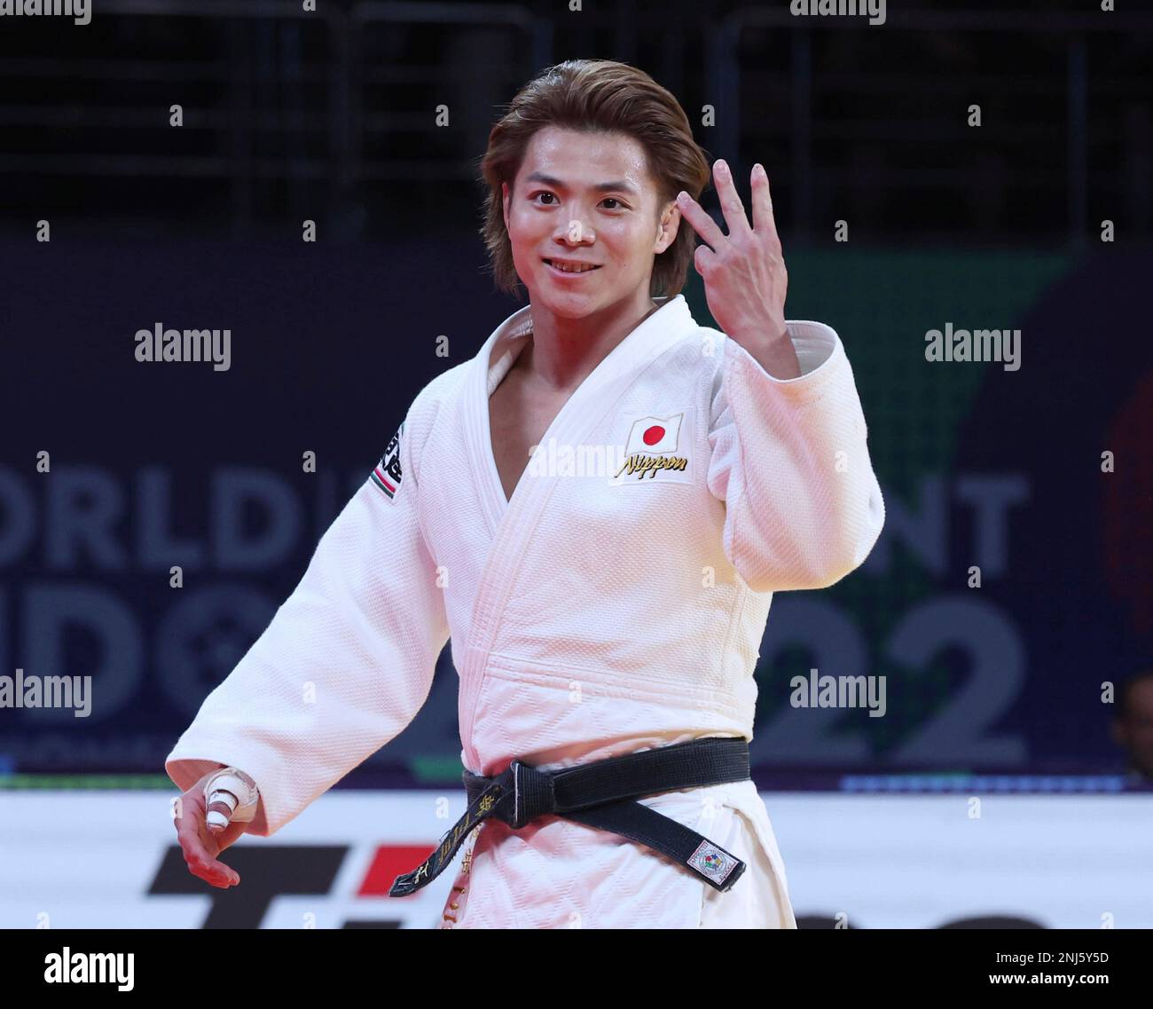 Hifumi Abe of Japan (white) reacts during men's under 66kg class final match against Joshiro ...
