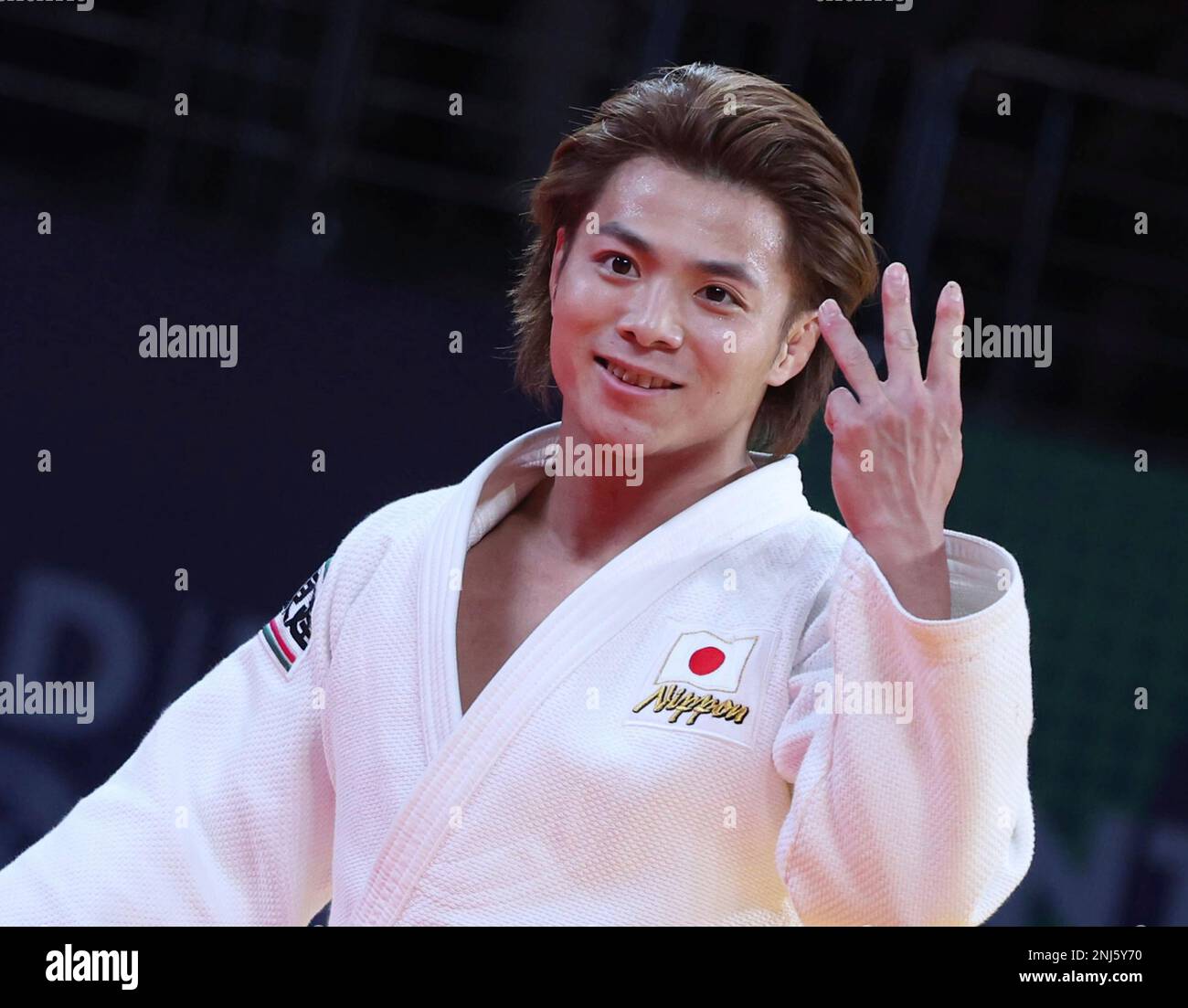 Hifumi Abe of Japan (white) reacts during men's under 66kg class final match against Joshiro ...