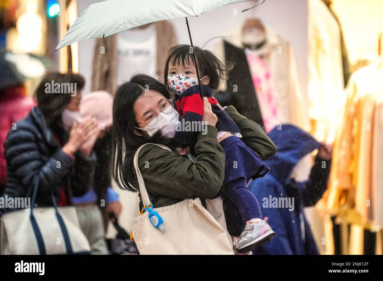 Rainy and cold weather in Hong Kong today. Pedestrians in Causeway Bay ...