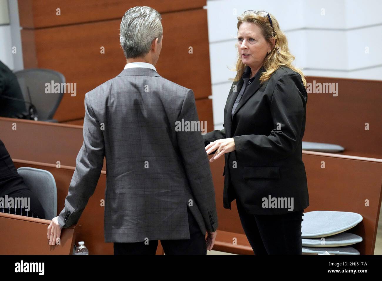 Debbie Hixon and Max Schachter speak during a break in the penalty ...