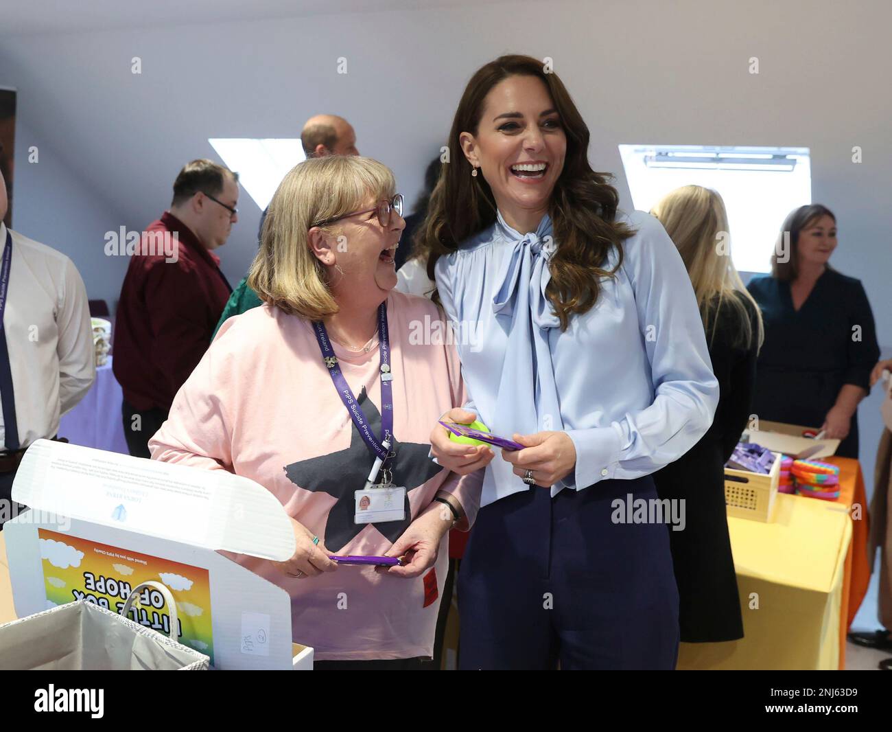 Britain's Kate, Princess of Wales speaks to a volunteer during a visit ...