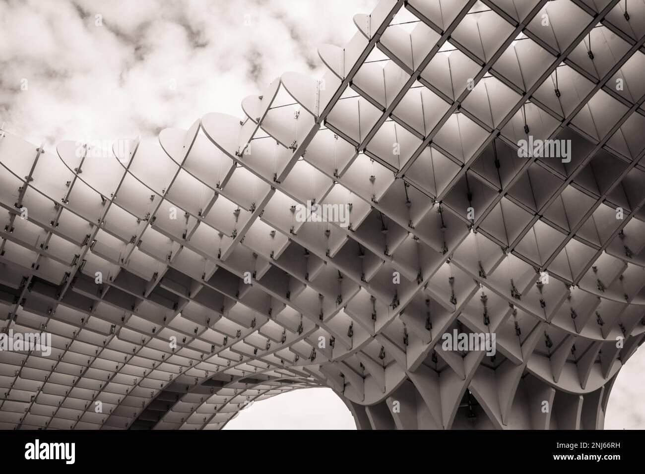 Criss cross, black and white sculpture with moody clouds and sky in ...