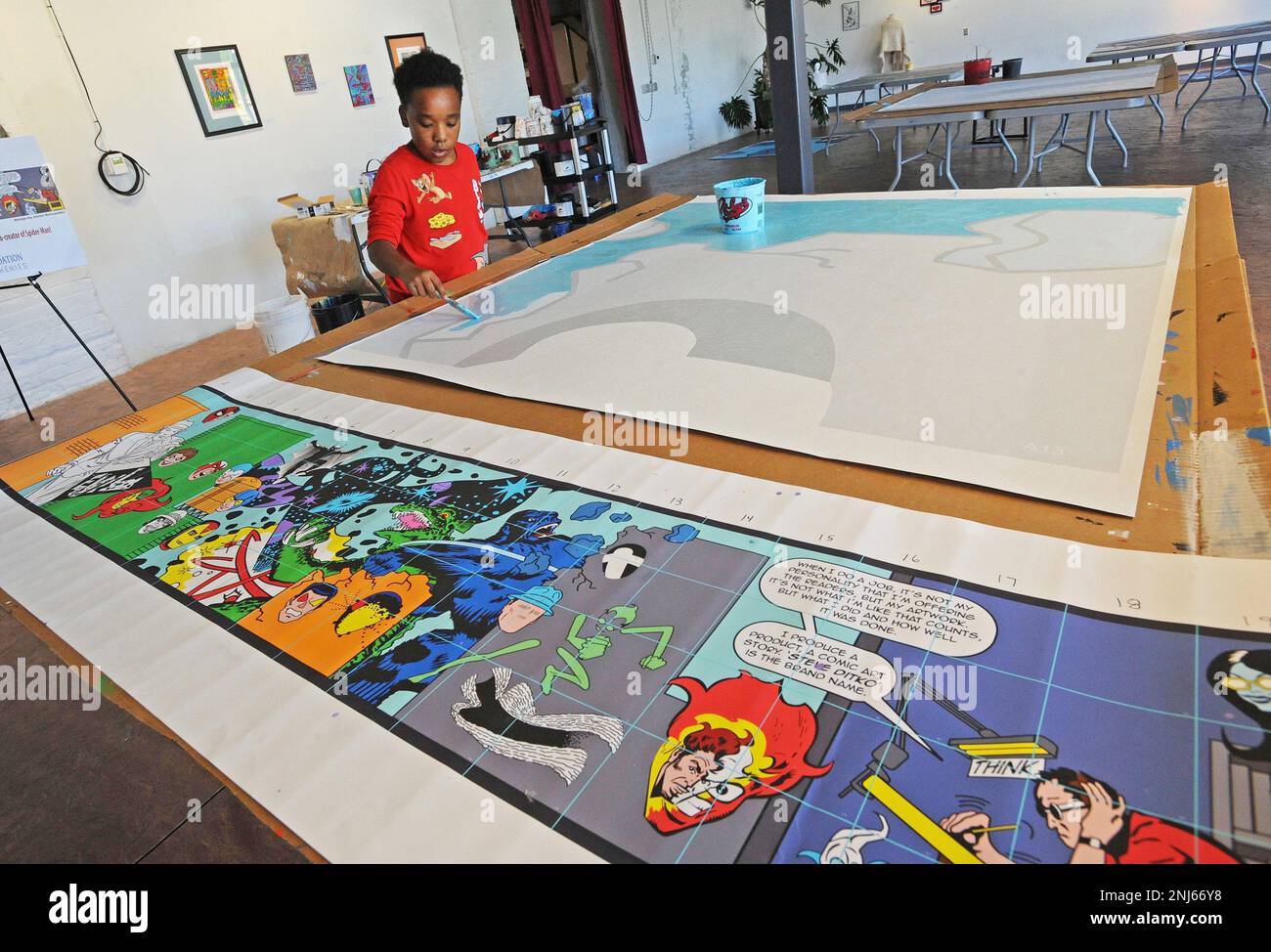 Zion Harris,11, works on a Steve Ditko mural panel at Bottle Works Arts ...