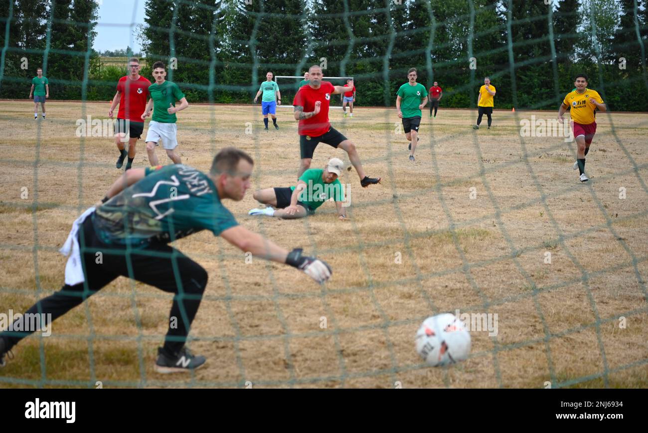 Airmen from the 702nd Munitions Support Squadron (in green) compete ...