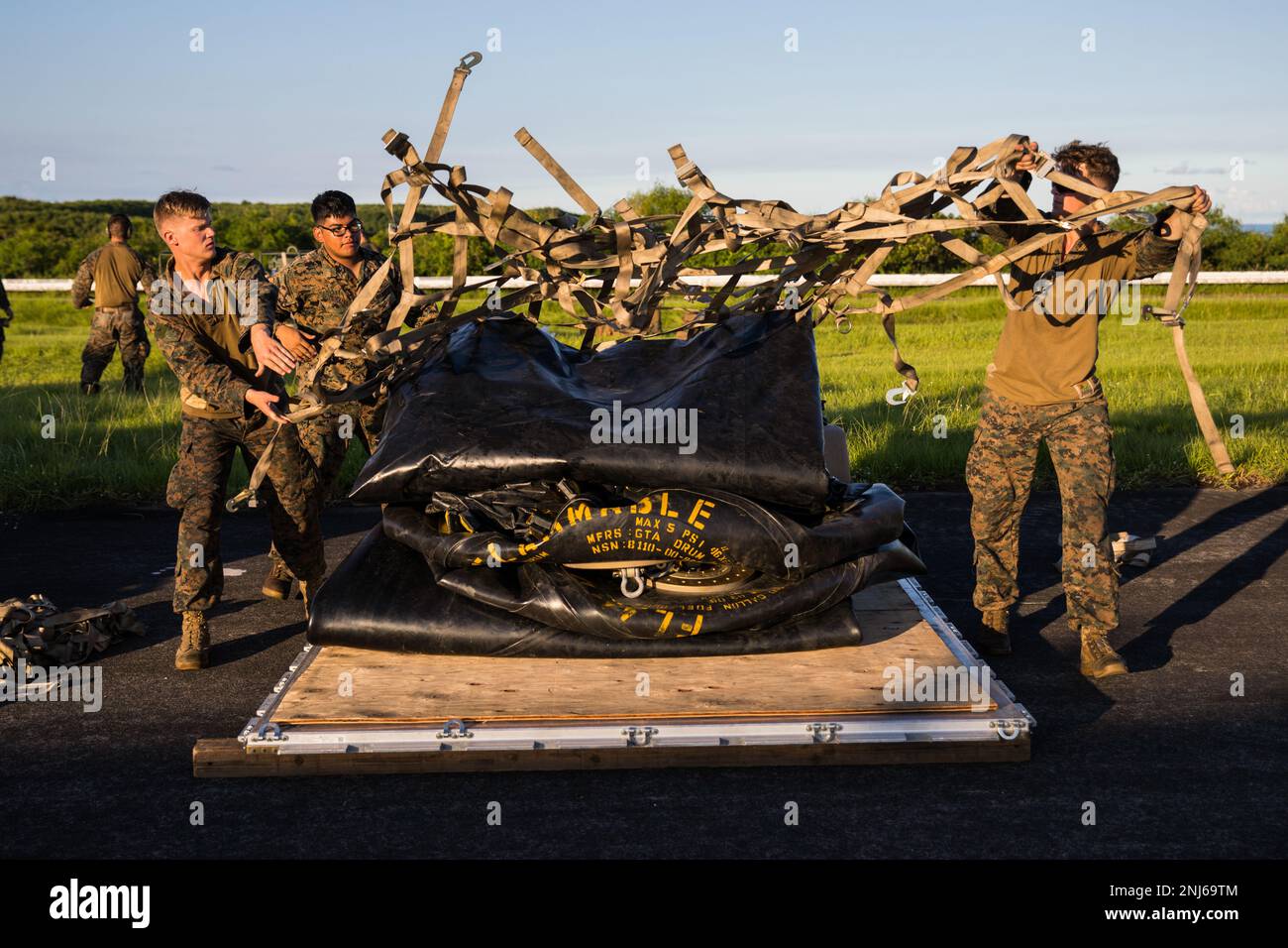 U.S. Marines with Marine Wing Support Squadron (MWSS) prepare to load a ...