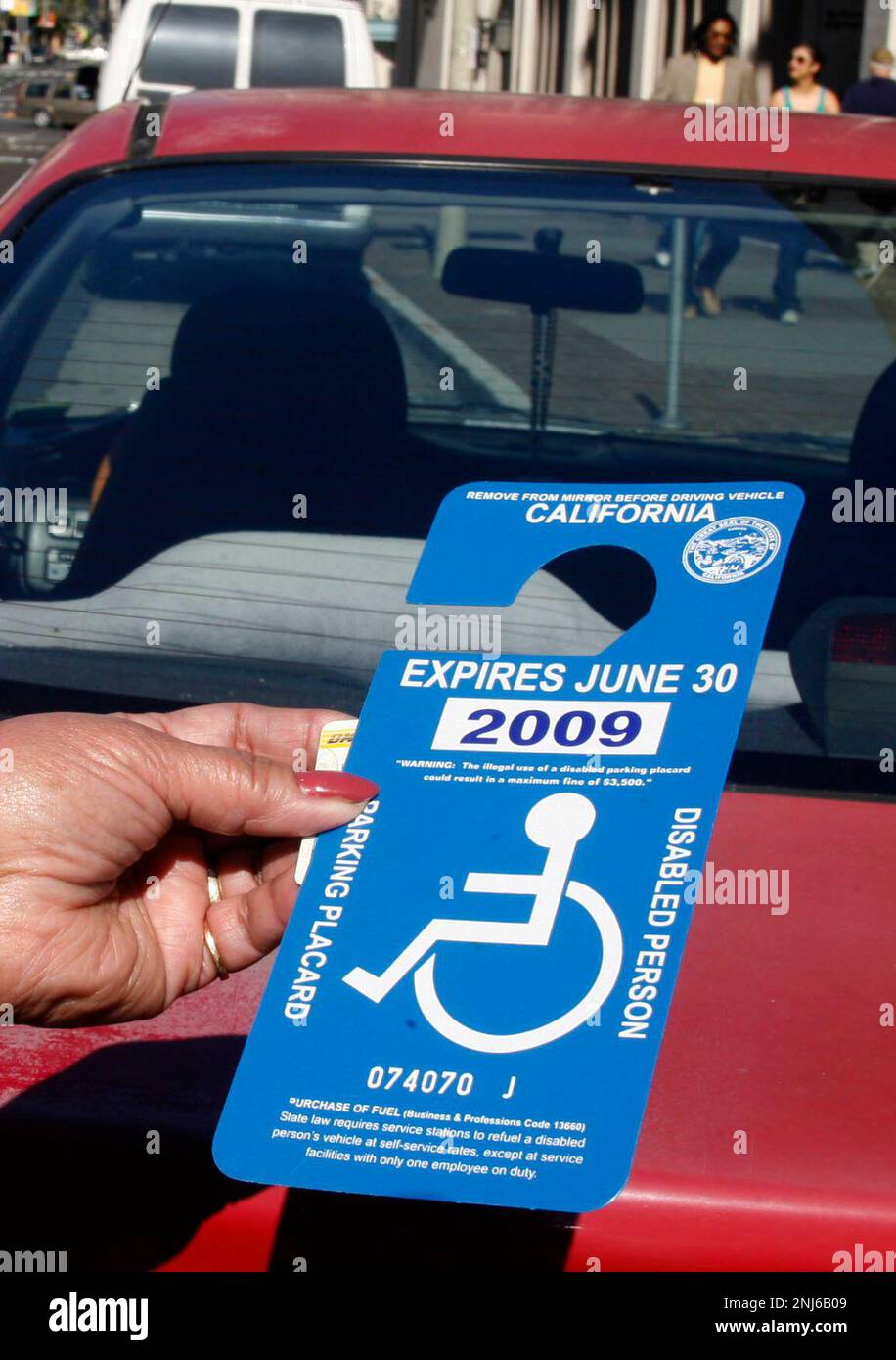 Eufrencia Lactaoeu,72 years old, shows her disabled placard while ...