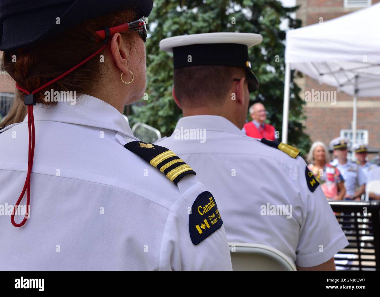 Two officers from the Canadian Coast Guard look on as Canadian Coast ...