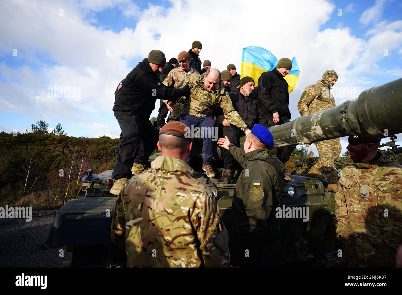 Defence Secretary Ben Wallace is helped off a tank during a visit to ...