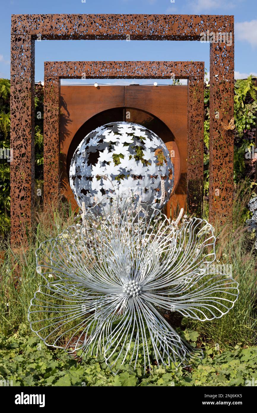 Sculpture at Chelsea Flower Show 2021. Silver metal flower, metal leaf ...