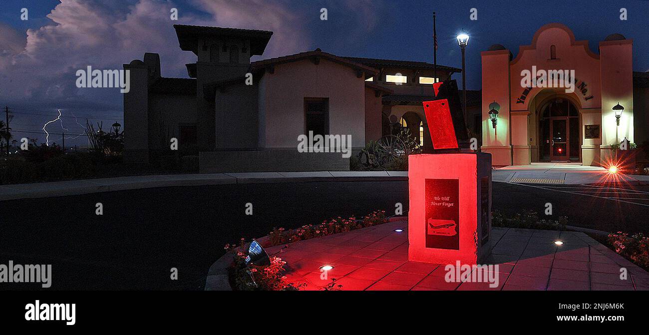 A bolt of lightning is seen on the northern horizon behind Yuma Fire ...