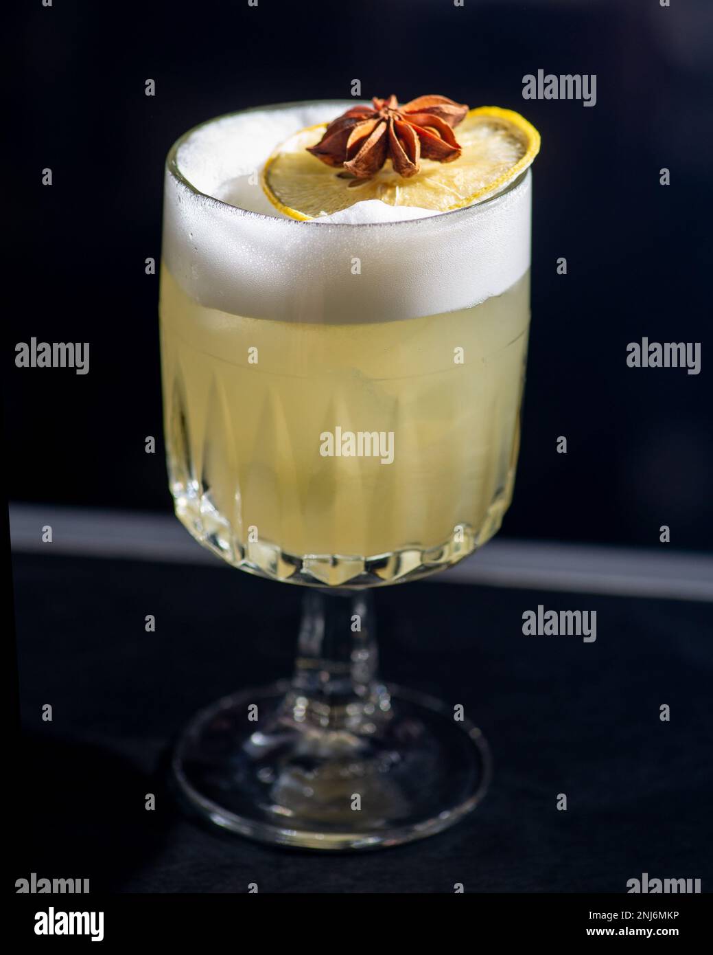 Yellow cocktail with foam on a dark background. Nightlife concept Stock ...